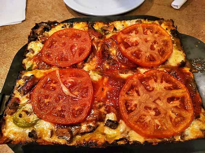 Who needs meat when vegetables look this good? Fresh tomatoes crown this Detroit-style masterpiece like jewels on a cheesy throne.