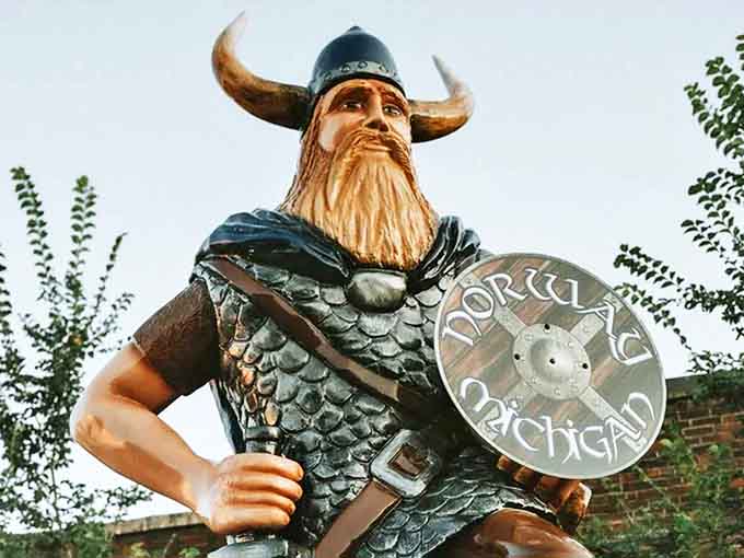 The town's guardian Viking stands watch with impressive beard and horned helmet, silently proclaiming Norway's proud Nordic roots.