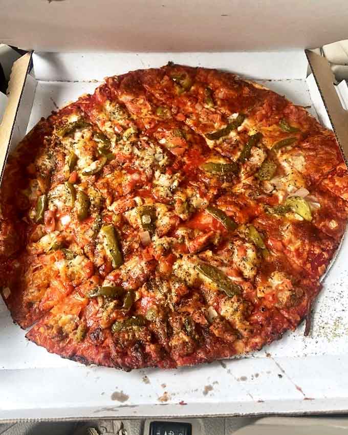 Cracker-thin yet sturdy enough for generous toppings, this pizza demonstrates why locals have been loyal for nearly a century.