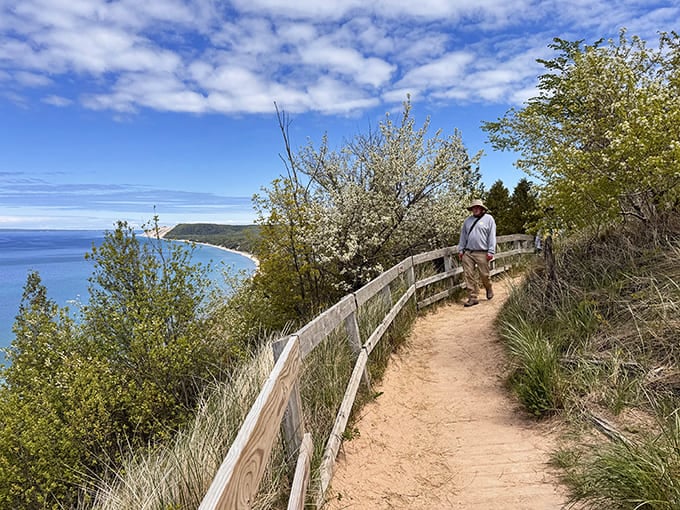 These weathered wooden railings have guided countless visitors safely along the bluff, standing as silent sentinels between hikers and the dramatic drop to the lake below.