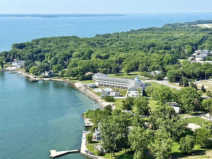 From above, Put-in-Bay reveals its perfect horseshoe harbor, where boats gather like colorful confetti on the blue canvas.