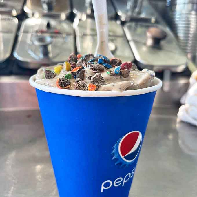 Ice cream artistry meets childhood nostalgia in this cup of joy, topped with colorful morsels that add both crunch and whimsy to every spoonful.