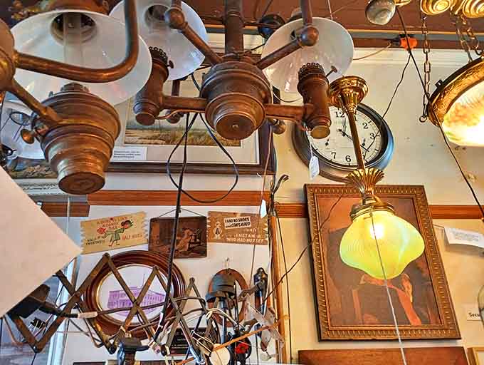 Vintage lighting fixtures create a canopy of illumination overhead, each pendant and shade representing a different era of American design sensibility.