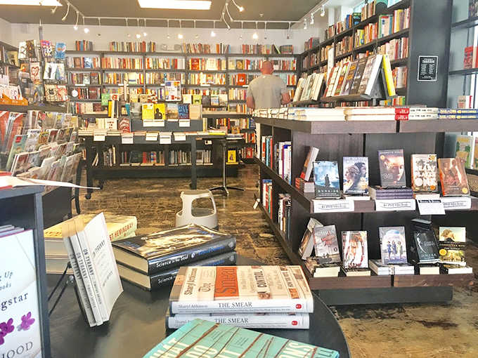 Worn wooden floors and thoughtfully arranged shelves create reading nooks that whisper, "Stay awhile," as afternoon light filters through windows onto carefully curated titles.