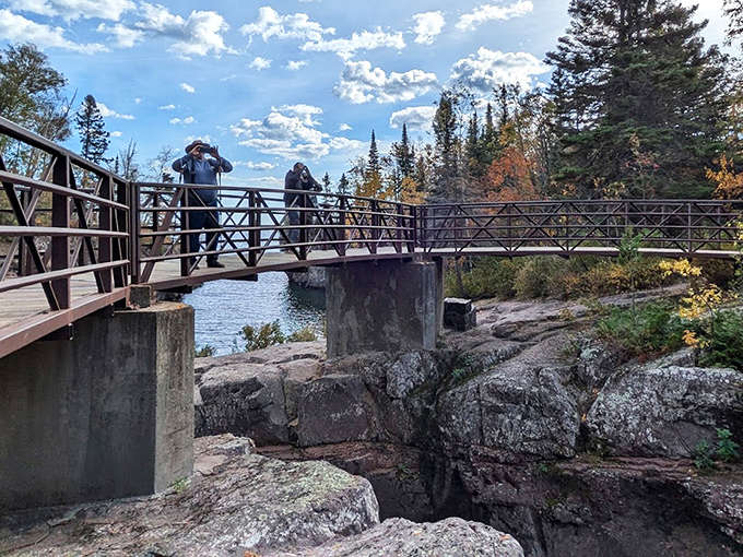 This sturdy bridge offers more than safe passage – it's the perfect vantage point for watching the hypnotic flow of water that's been carving this landscape for millennia.