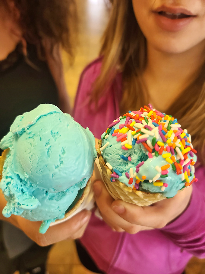 Blue ice cream with rainbow sprinkles &ndash; childhood joy frozen in time, held by hands that understand the serious business of dessert happiness.