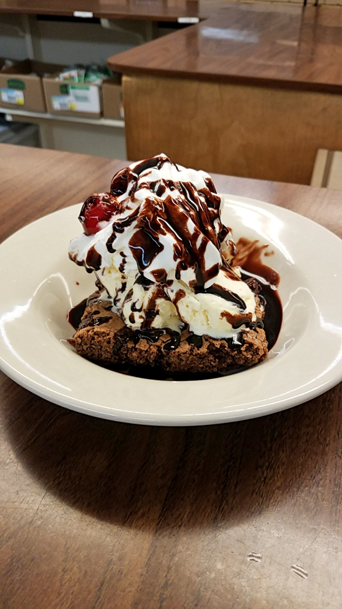 This isn't just dessert, it's therapy &ndash; a warm brownie crowned with ice cream, whipped cream, and chocolate drizzle that makes problems temporarily disappear.