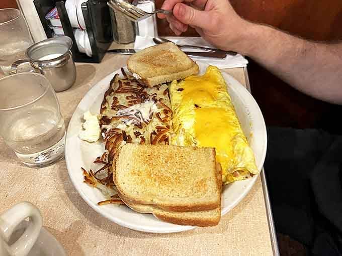 Golden cheese melts into fluffy eggs alongside hashbrowns with that ideal crisp-to-tender ratio that potato dreams are made of.