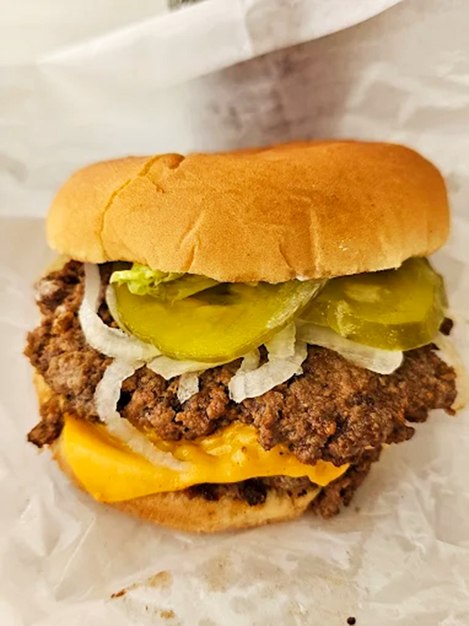 Classic cheeseburger: Nothing fancy, just beef perfection on a soft bun with melty cheese, pickles, and onions &ndash; the way burgers were meant to be.