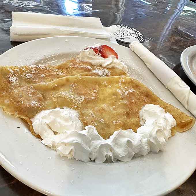 Golden, paper-thin perfection cradles fresh cream and berries &ndash; proof that sometimes the simplest pleasures deliver the most profound satisfaction.