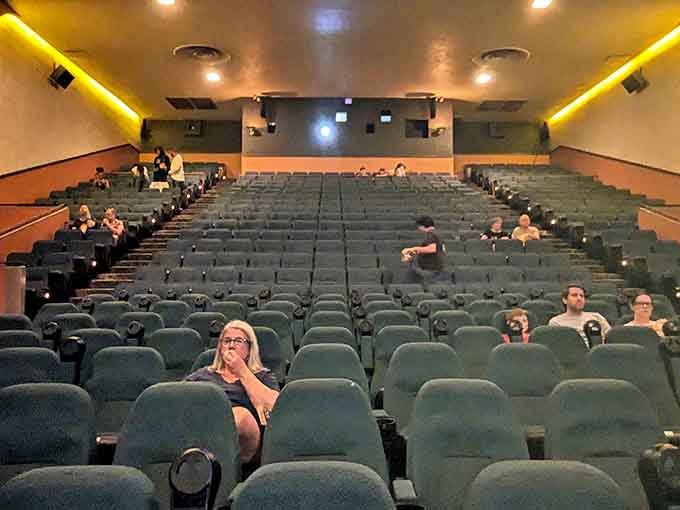 The auditorium fills with anticipation as viewers settle in, strangers united by the shared experience only a single-screen theater provides.