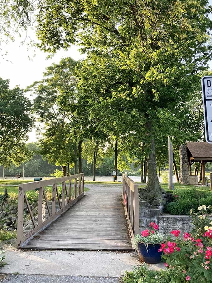 This wooden footbridge invites visitors to cross over to adventure, with colorful planters adding a touch of local pride.