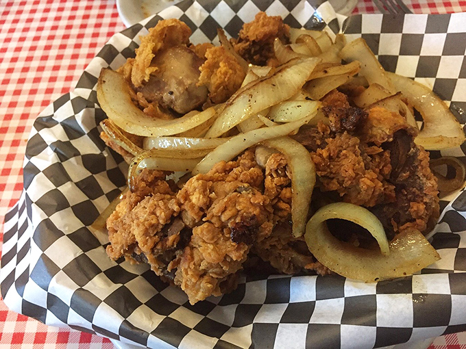 Crispy fried chicken nestled alongside saut&eacute;ed onions &ndash; a simple combination that delivers a master class in comfort food.
