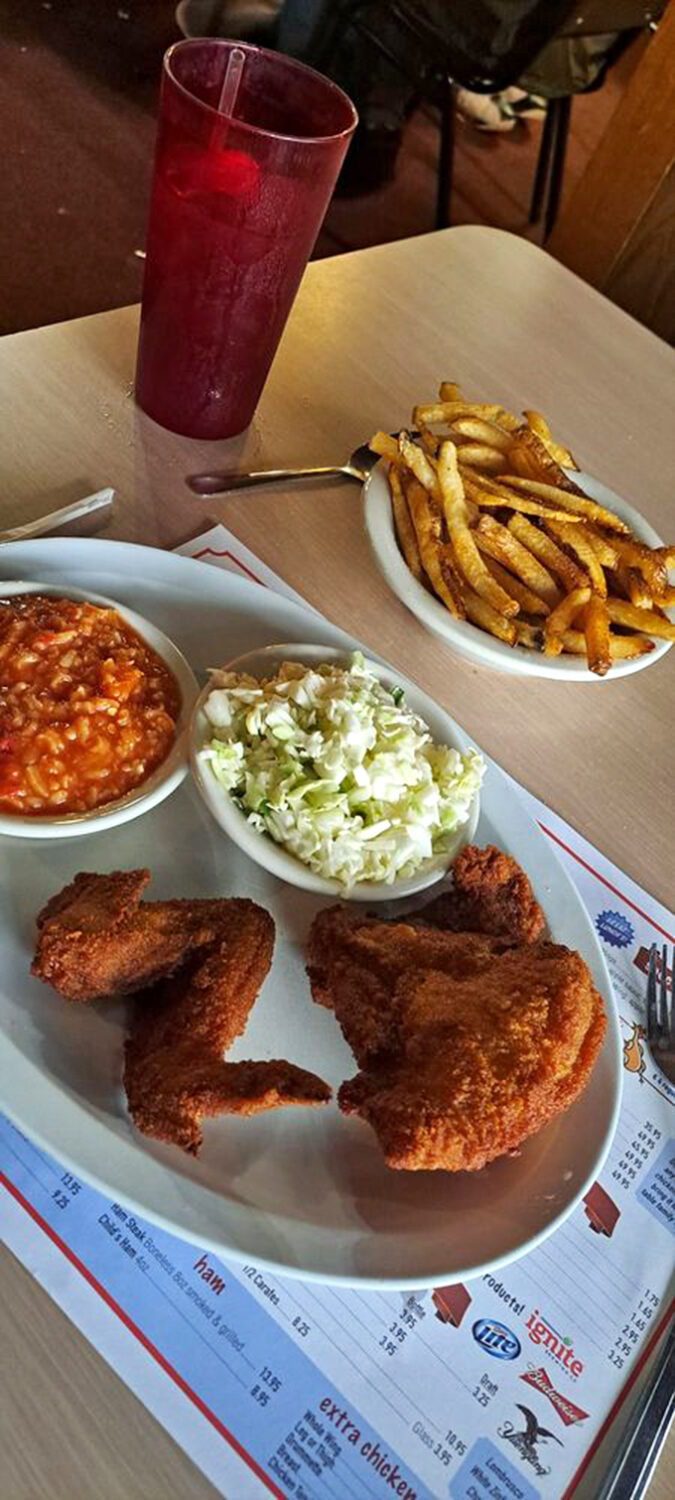 A symphony of crunch and tenderness &ndash; DeVore's fried chicken dinner with crispy fries, creamy coleslaw, and that magical dipping sauce.