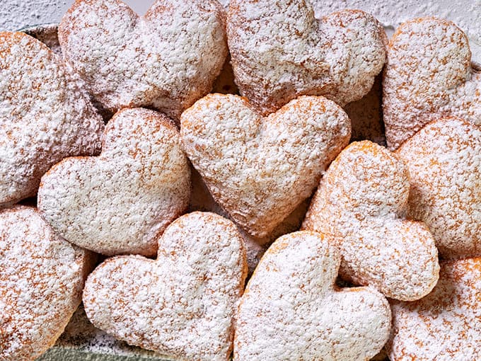 Heart-shaped beignets prove that love and carbohydrates go hand in hand, perfect for romance or just treating yourself on a random Wednesday.