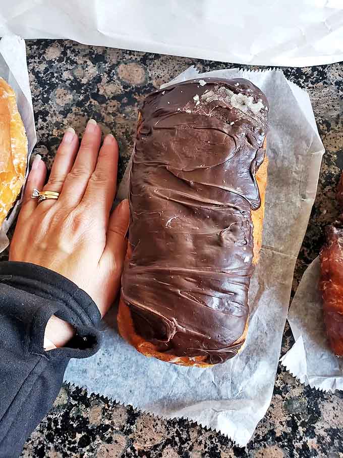 Size comparison that proves these aren't just donuts &ndash; they're full-fledged dessert commitments requiring both hands and zero regrets.