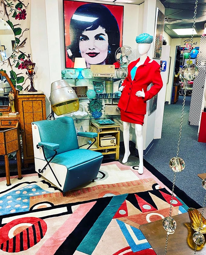 Jackie O would approve of this mod vignette, complete with turquoise chair and mannequin rocking a power suit that screams "corner office, 1965."