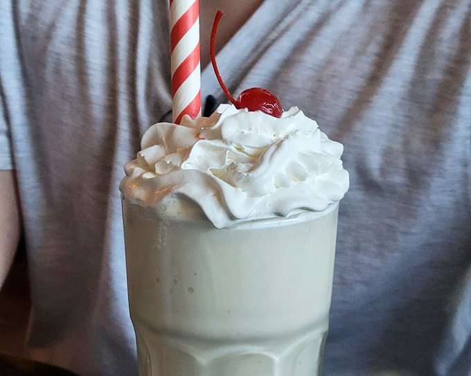 The perfect finale &ndash; whipped cream mountain, cherry summit, and that iconic striped straw make this milkshake as photogenic as it is delicious.