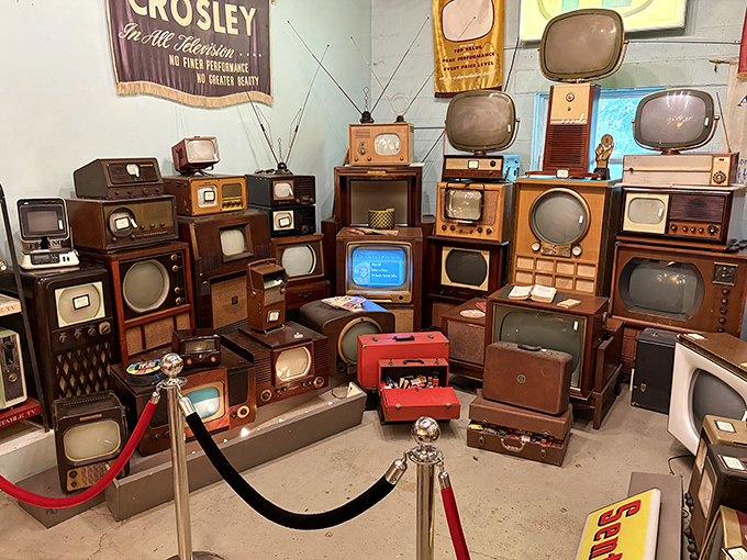 Television's evolutionary timeline on display – from wooden cabinets with tiny screens to the dawn of color, each set a portal to bygone broadcasts.