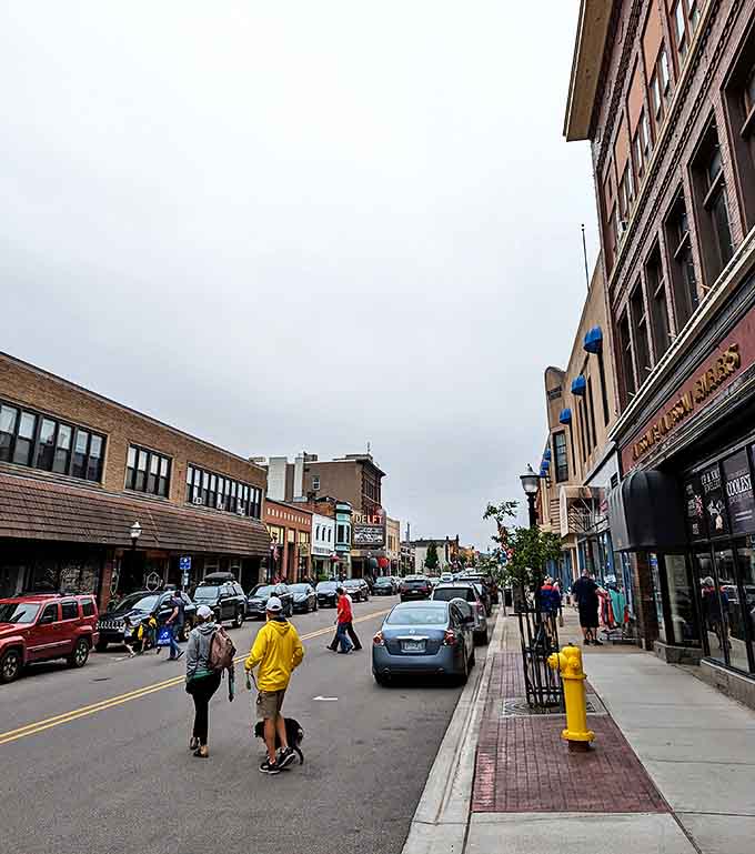 Pedestrians navigate Marquette's walkable downtown, where cars slow down and people are the priority.
