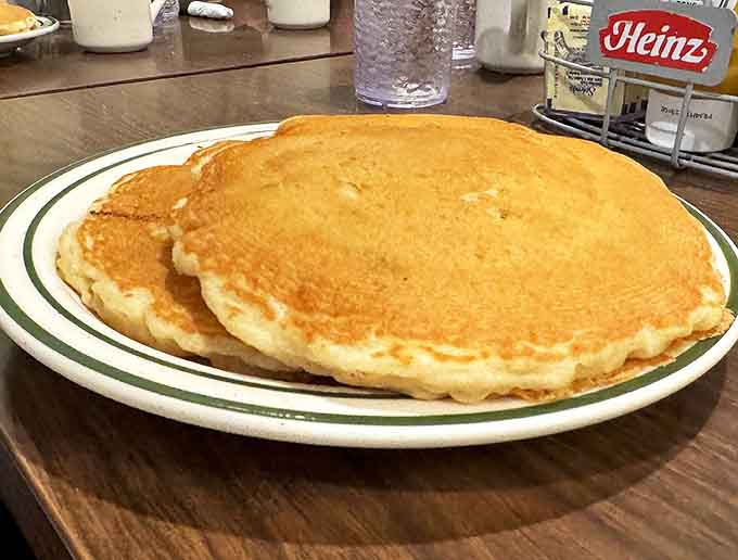 Pancakes so perfectly golden and fluffy they look like they're auditioning for a breakfast commercial. The syrup is just waiting to dive in!