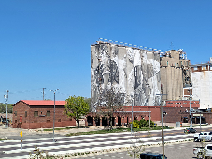 Historic red brick buildings create a charming contrast with the modern mural art, showcasing Mankato's blend of heritage and contemporary vision.