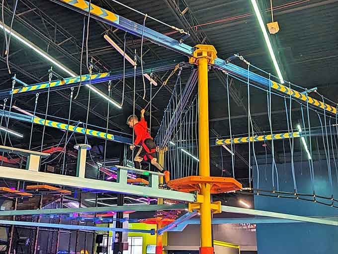The rope courses suspend reality along with participants, creating aerial highways where balance meets bravery in a test of coordination.