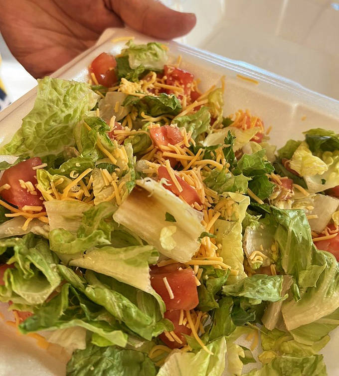 Even the salad gets special treatment here &ndash; crisp lettuce, juicy tomatoes, and shredded cheese create a fresh counterpoint to the heartier options.