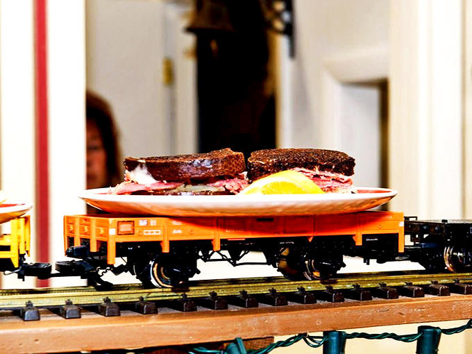 Who needs servers when you've got rails? This sandwich makes its journey to hungry patrons aboard a charming miniature freight car.
