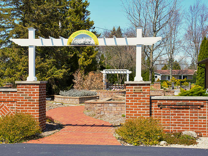Simpson Garden Park's elegant entrance promises botanical delights beyond, with brick pathways leading visitors into a carefully curated natural sanctuary.