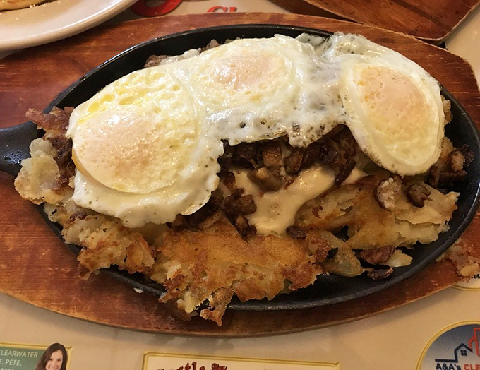 When breakfast meets art: eggs perched atop a mountain of home fries and savory ingredients, creating the perfect bite every single time.