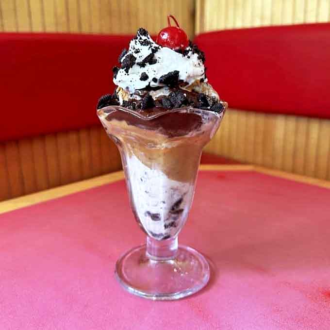 A classic sundae that defies gravity and good sense&mdash;chocolate decadence topped with whipped cream, Oreo crumbles, and that essential cherry on top.