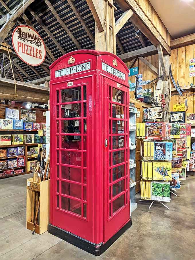 This classic British telephone booth stands as a cheerful red sentinel among puzzles and games, a perfect spot for pretending you're calling from another era.