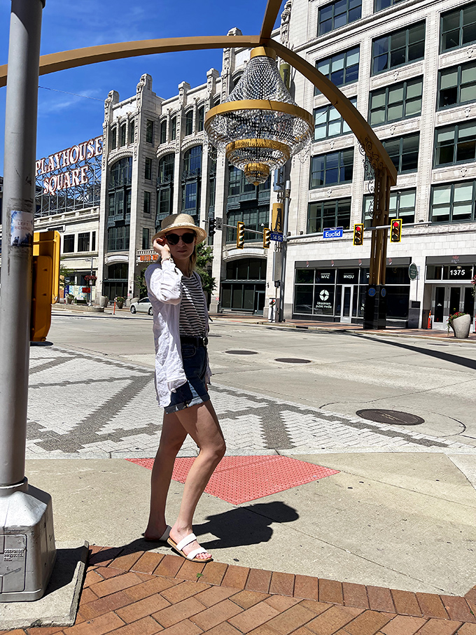 Visitors stroll beneath the massive chandelier, where everyday sidewalks become impromptu red carpets for everyone passing through.