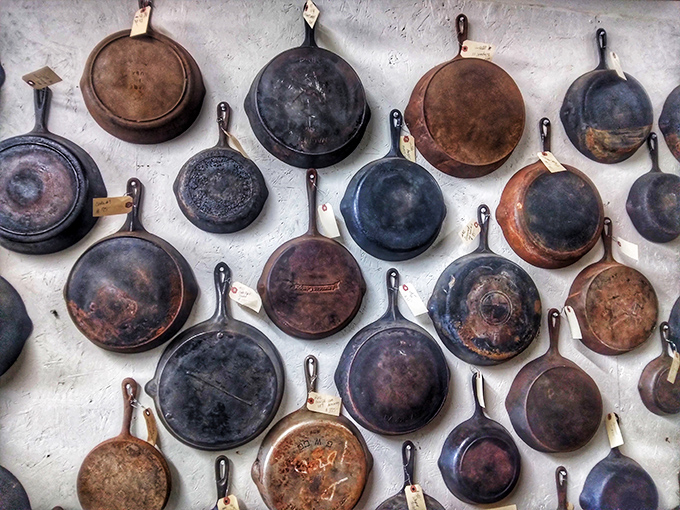 Kitchen history hangs on display &ndash; these cast iron skillets have fried countless meals and carry the seasoning of generations.