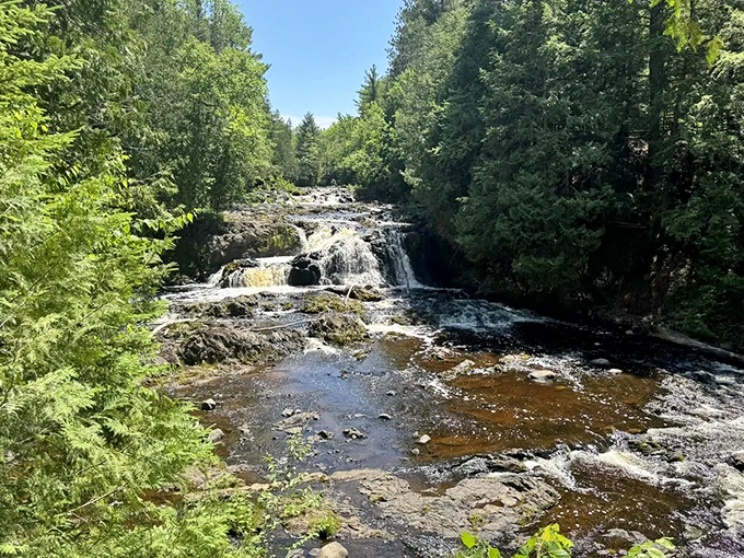 Brownstone Falls showcases Wisconsin's geological history, where iron-rich rocks create a rusty backdrop for the crystal-clear tumbling waters.