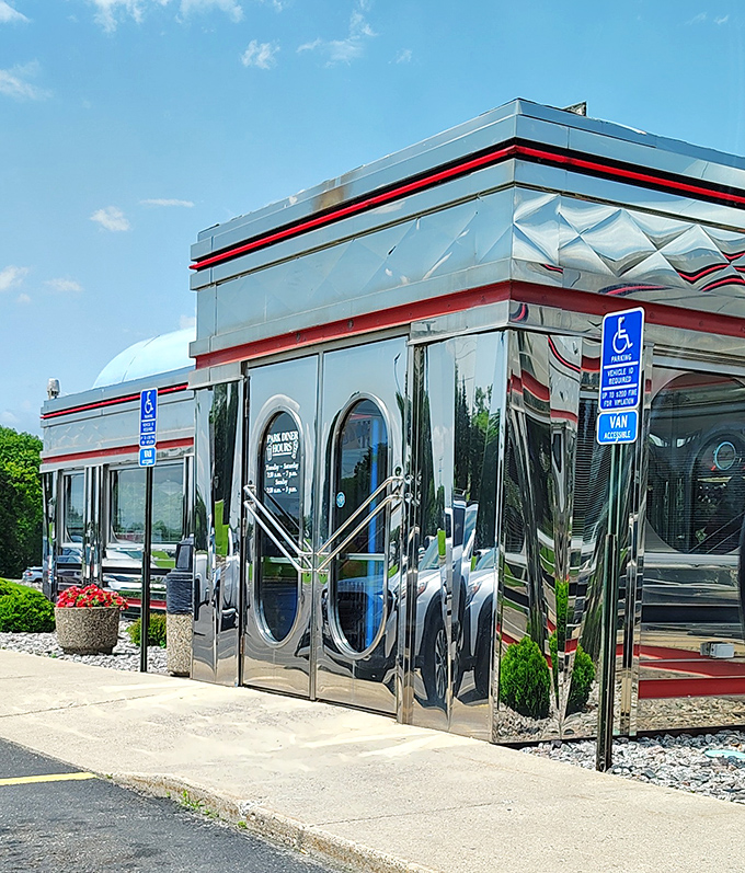 Park Diner's gleaming chrome exterior reflects the Minnesota sky, showcasing the diamond pattern trim that defines classic diner architecture.