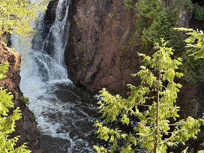 The dramatic plunge of Brownstone Falls cuts through ancient volcanic rock, creating a scene that feels more Colorado than Wisconsin.