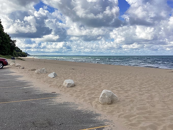 The peaceful shoreline at Buttersville offers a perfect escape, where gentle waves meet sandy beaches beneath dramatic skies.