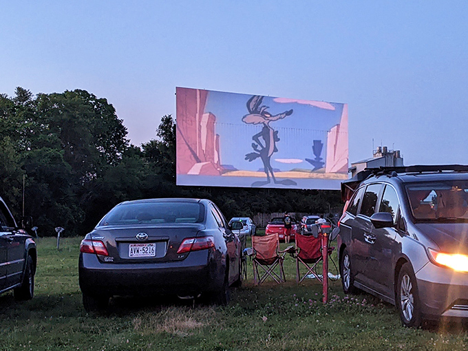 The sun sets behind Stardust Drive-In's massive screen, creating the perfect backdrop for an evening of outdoor movie magic in Chetek.