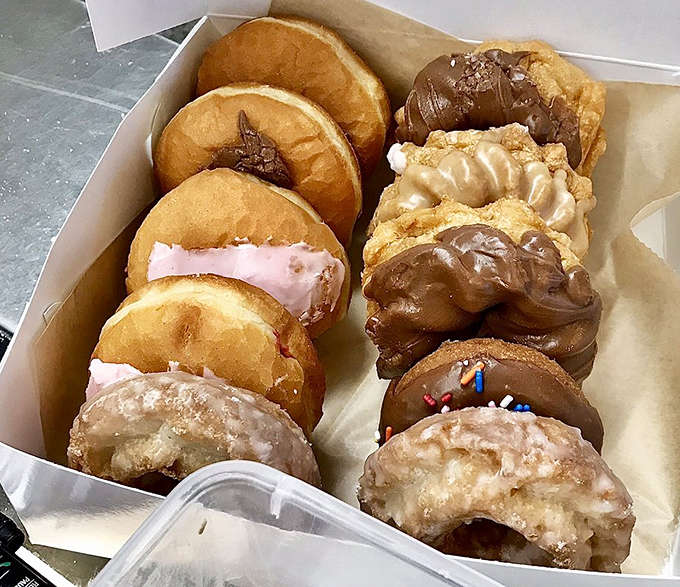 Donut heaven in cardboard form &ndash; a variety box showcases Dutch Girl's range, from classic glazed to vibrant red velvet treats.