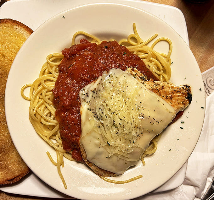 Comfort food elevated to art form &ndash; tender chicken beneath a blanket of bubbling cheese and tangy marinara.