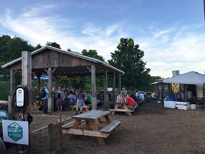 Local gathering spots like this rustic pavilion become impromptu community dining rooms, where shared meals foster connections under string lights and open skies.
