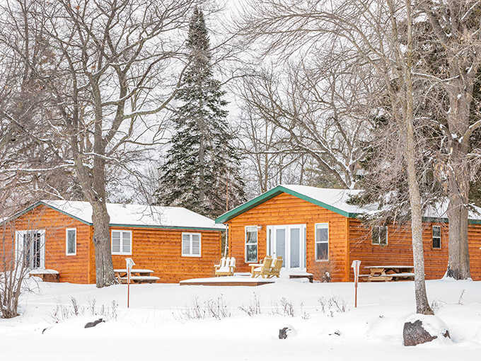 Winter transforms Big Rock Resort into a snow-dusted wonderland, where cozy cabins promise warmth against the beautiful Minnesota chill.