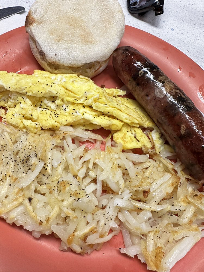 Breakfast perfection on a plate &ndash; eggs, hash browns, and sausage in harmonious balance.