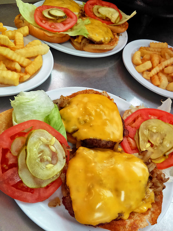 Cheeseburgers stacked high with fresh veggies and melty American cheese &ndash; proof that perfection doesn't need reinvention, just quality ingredients.