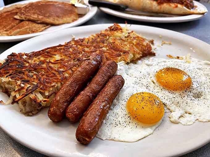 The classic breakfast trinity: perfectly cooked eggs, sausage links with just the right snap, and those impossibly crispy hash browns.