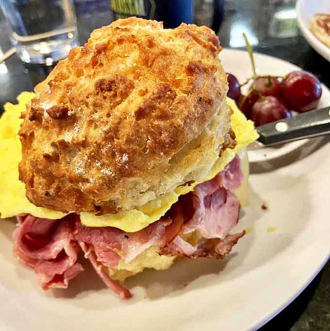 This ham and egg biscuit sandwich comes with a side of fresh cherries, because balance is important when you're indulging in breakfast perfection.