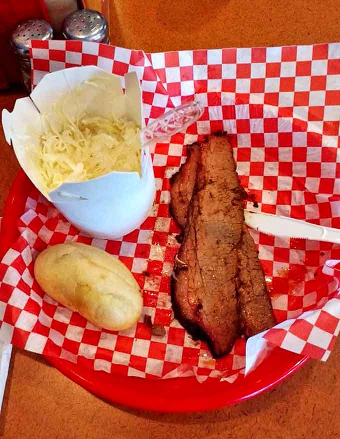 A perfect barbecue trinity: tender brisket, creamy coleslaw, and a pillowy potato roll, simple pleasures elevated to art form.