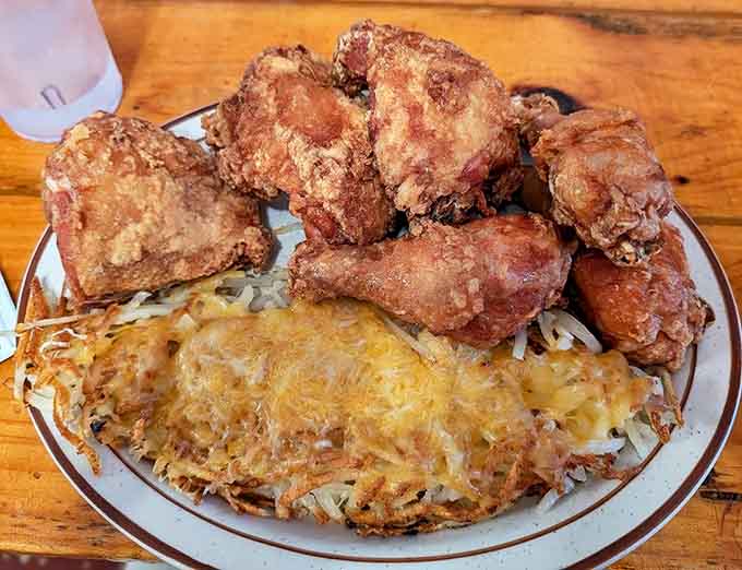 A mountain of crispy broasted chicken shares the spotlight with golden hash browns, creating the ultimate Midwest protein-potato power couple.